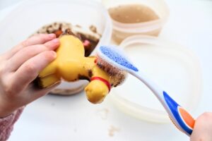 “Wash the Muddy Farm Animals” Sensory Bin - The Craft-at-Home Family